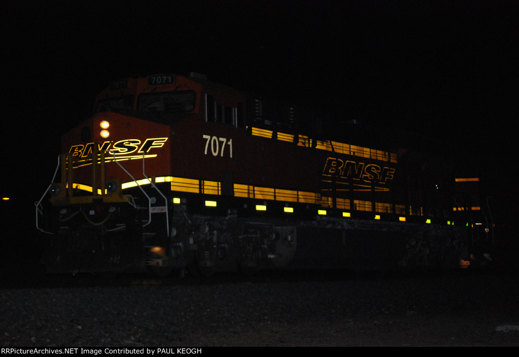 BNSF 7071 Lights Up Her BNSF Swoosh Logo Paint as she Heads east as a Rear DPU on a Stack Train.